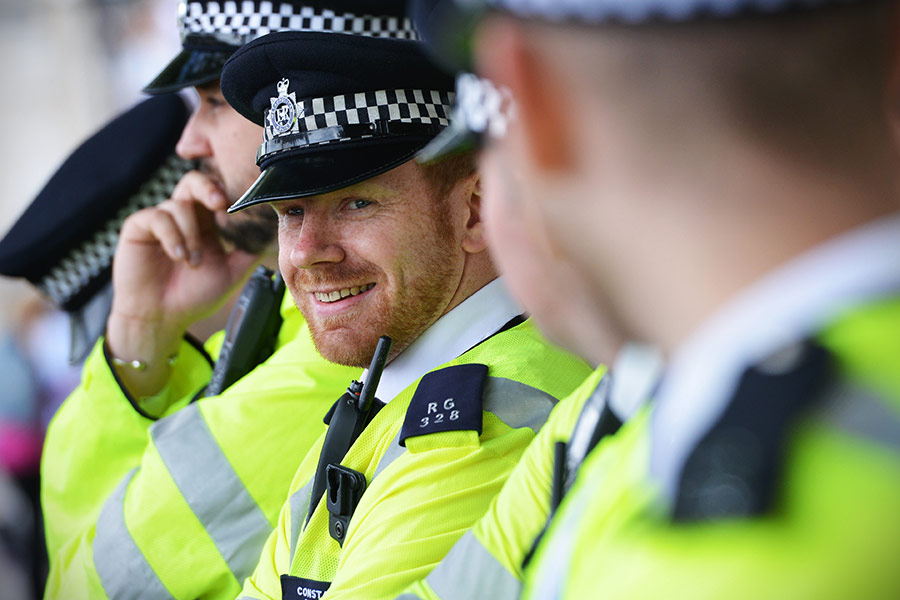 Gun-carrying UK police officers respond to criticism with # ...